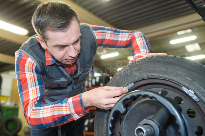 Mechanic Balancing Car Wheel Stock Photo - Image of problem, mature ...