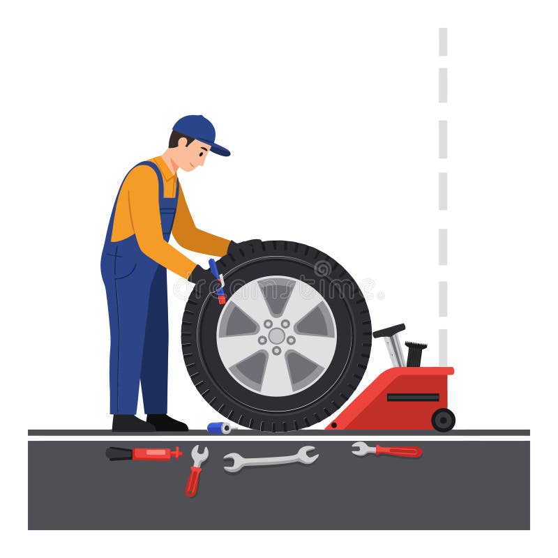 A Mechanic in Blue Overalls Changing a Tire Using Tools on a Workshop ...
