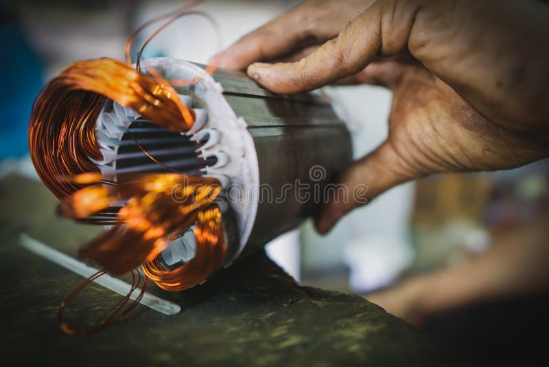 The Mechanic is Bringing the Copper Wire into the Stator To Create a ...