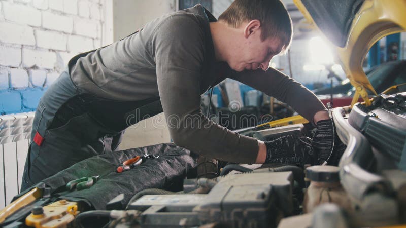 Mechanic in Car Repairing Service - Diagnostics in Engine Compartment ...