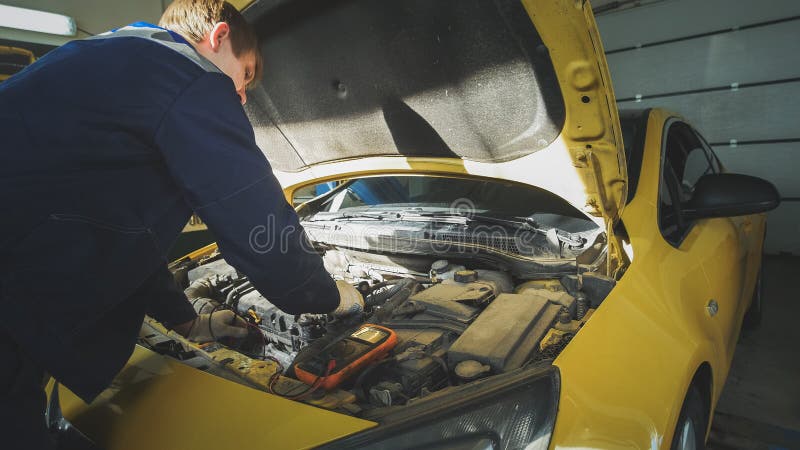 Mechanic Caucasian in Car Service - Repairing in Engine Compartment ...