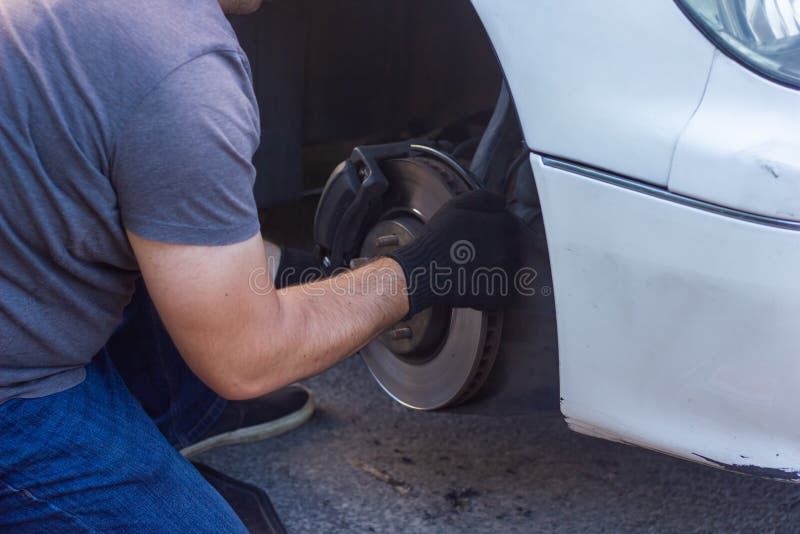Mechanic Changing Car Wheel, Car Mechanic Changing the Wheel of a Car ...