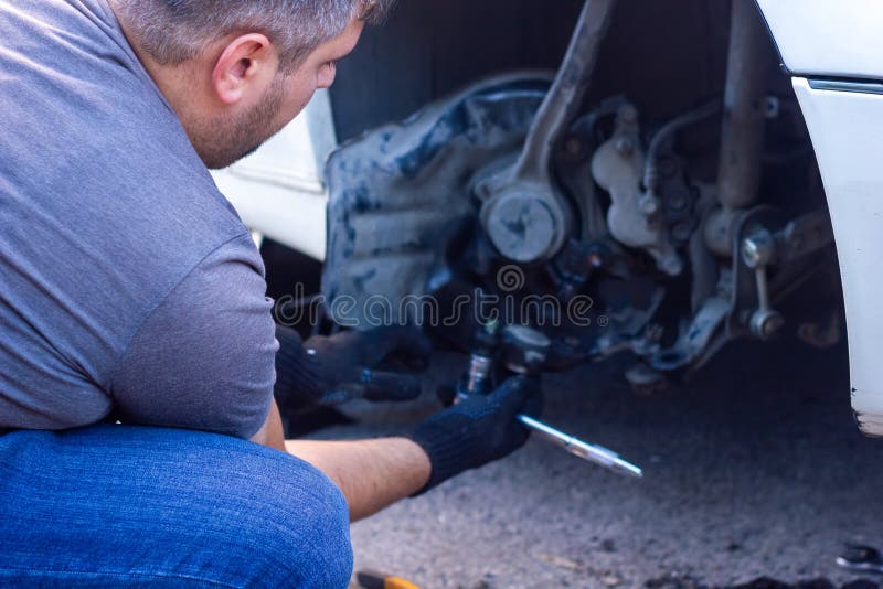 Mechanic Changing Car Wheel, Car Mechanic Changing the Wheel of a Car ...