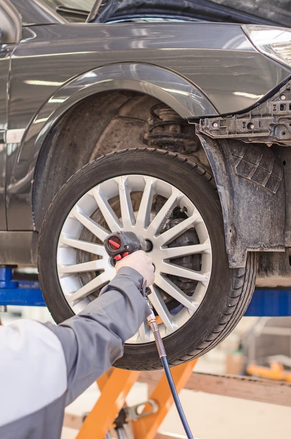 Mechanic Changing Car Wheel. Stock Image - Image of removing, changing ...