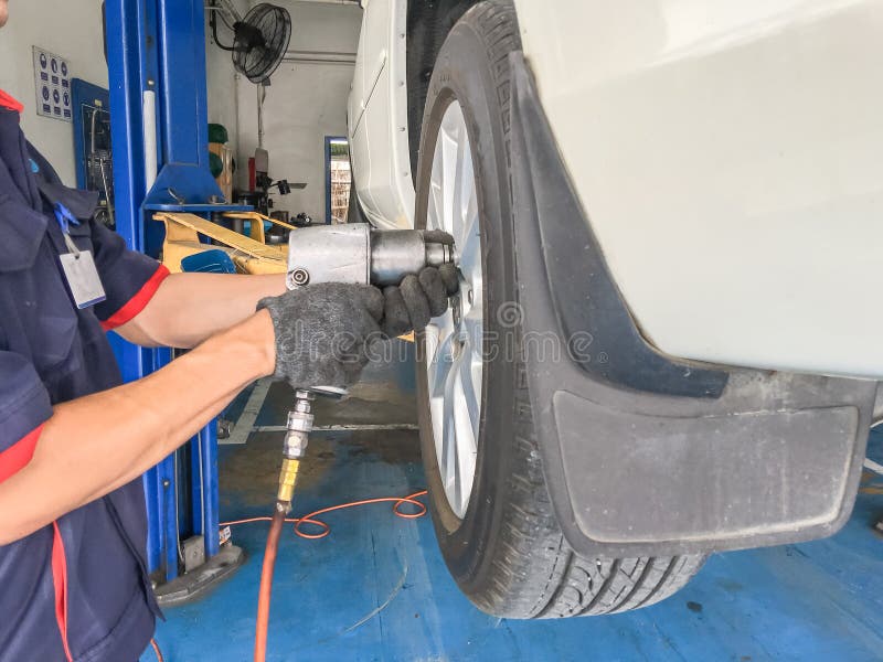 Mechanic changing a tire stock image. Image of shop, maintenance - 83540195