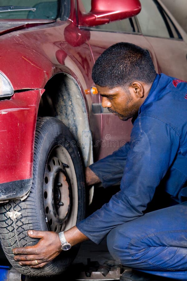 Mechanic changing tyre stock image. Image of auto, closeup - 7457269