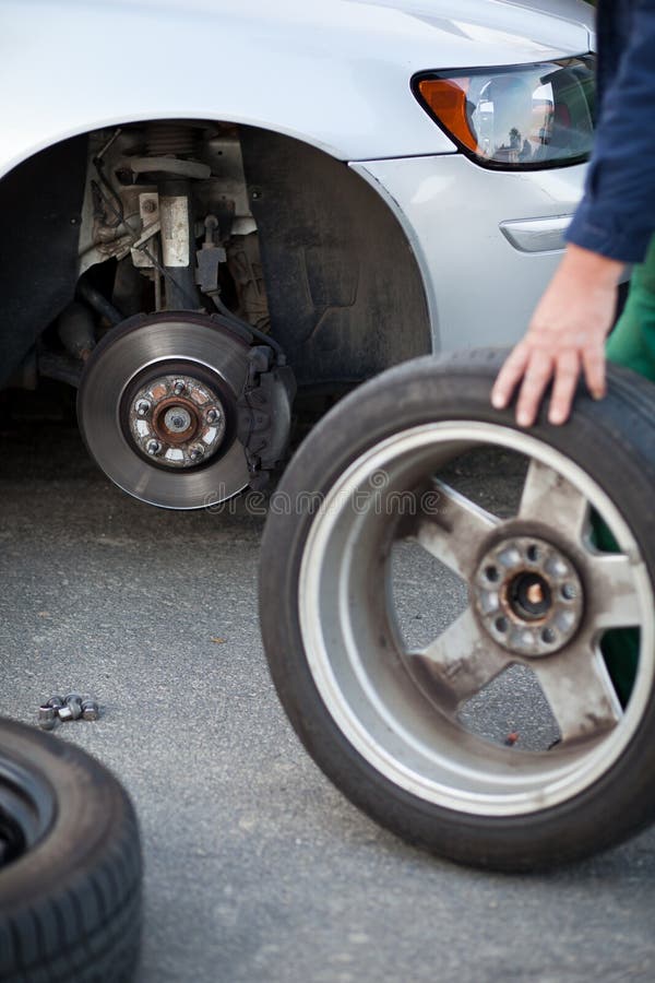 Mechanic Changing a Wheel of a Modern Car Stock Photo - Image of dirty ...
