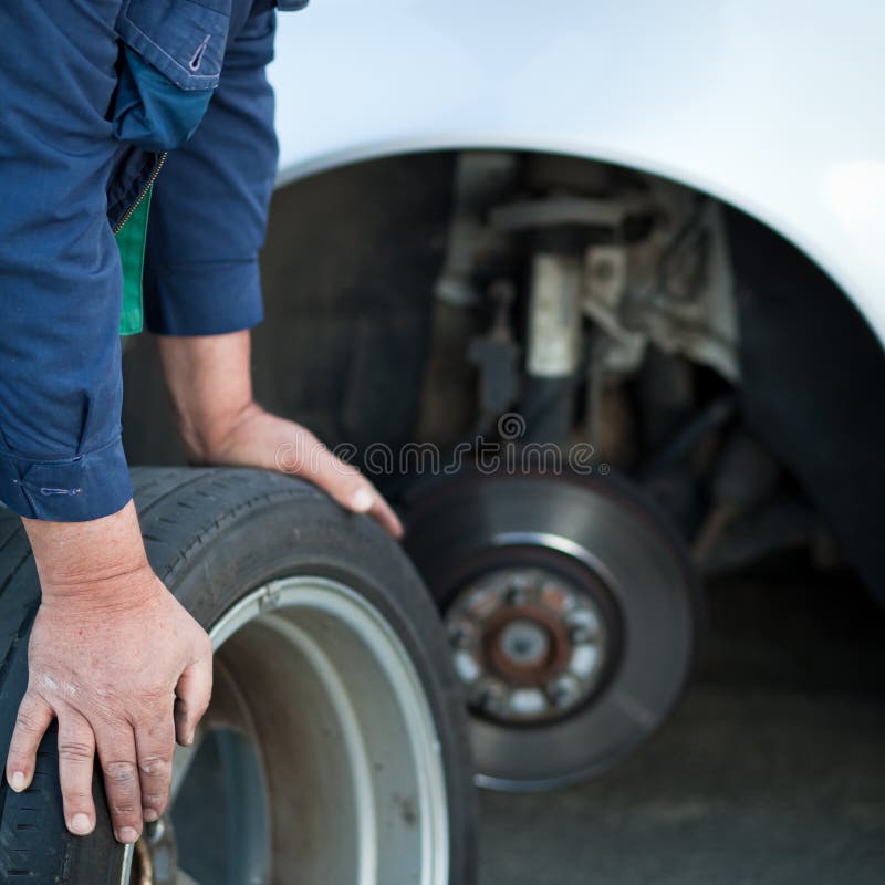 Mechanic Changing a Wheel of a Modern Car Stock Image - Image of shop ...