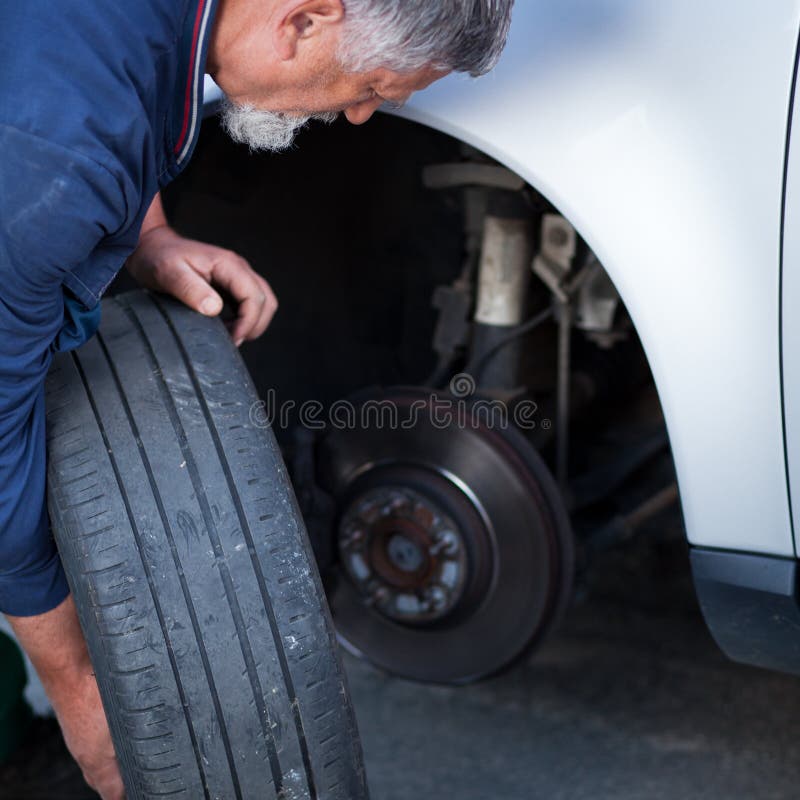 Mechanic Changing a Wheel of a Modern Car Stock Photo - Image of ...
