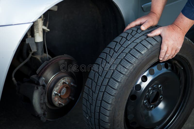Mechanic Changing a Wheel of a Modern Car Stock Image - Image of ...