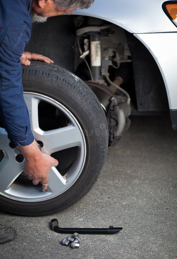 Mechanic Changing a Wheel of a Modern Car Stock Photo - Image of shop ...