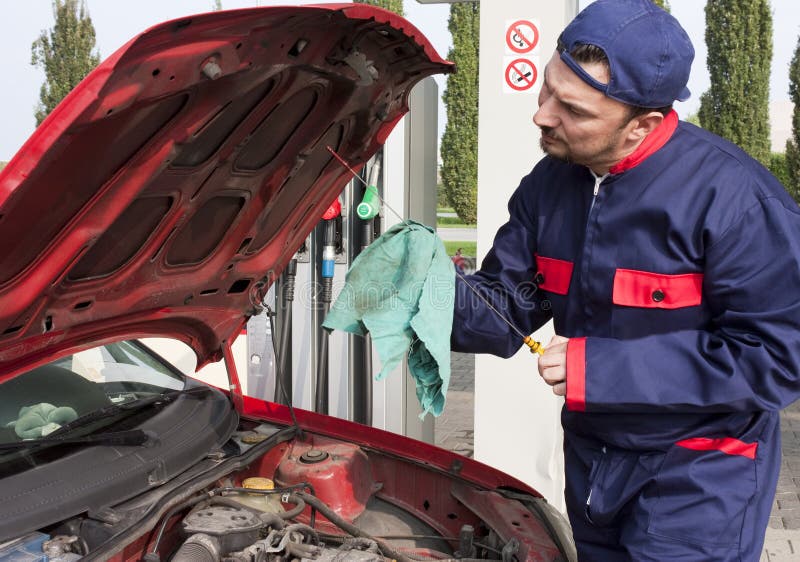 Car Mechanic Checking Oil Quality the Engine Motor Car Transmission and ...