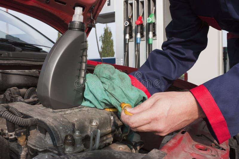 Car Mechanic Checking Oil Quality the Engine Motor Car Transmission and ...