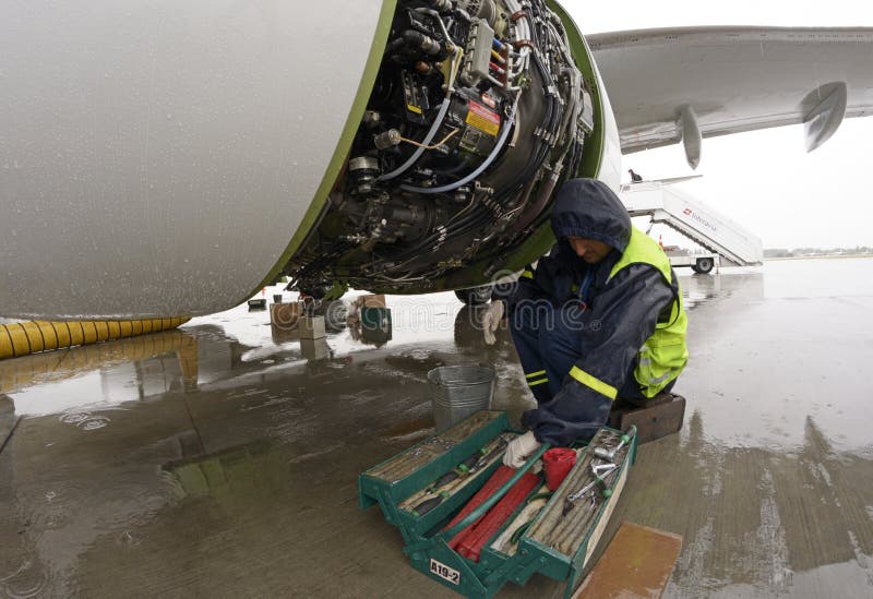 Mechanic Checking the Engine of an Aircraft on Plane Parking Space ...