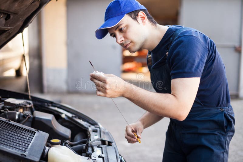Mechanic Checking the Oil Level Stock Photo - Image of people, person ...