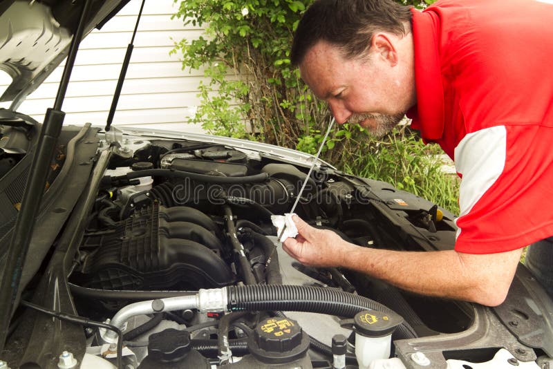 A Mechanic Checking the Oil in a Newer Car Stock Photo - Image of ...