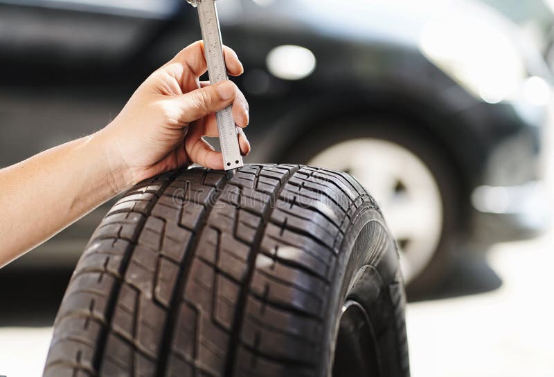 Mechanic Checking Tire Tread Measurements with Calipers Tool Stock ...