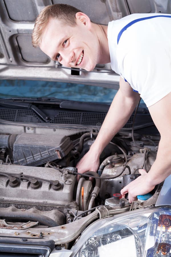 Mechanic Checks a Car Engine Stock Photo - Image of examining, work ...