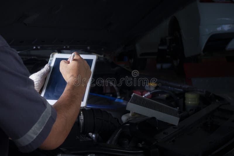 The Mechanic Checks the Engine Using Tablet Computer Technology ...
