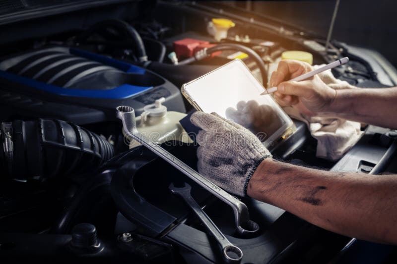 The Mechanic Checks the Engine Using Tablet Computer Technology ...