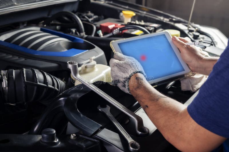 The Mechanic Checks the Engine Using Tablet Computer Technology ...