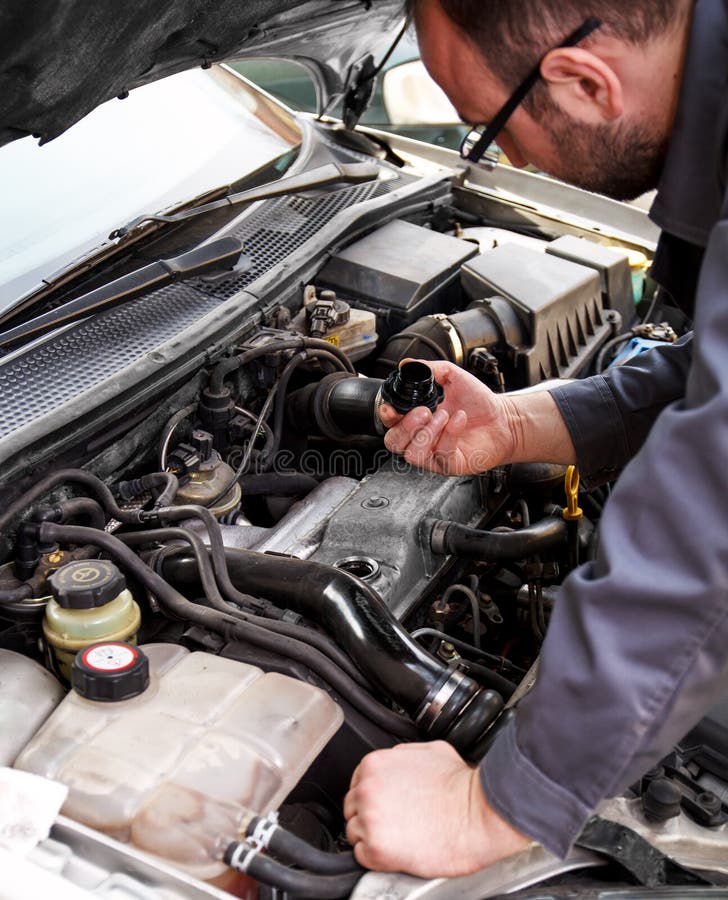 Mechanic Checks Oil Car Being Repaired Stock Photos - Free & Royalty ...