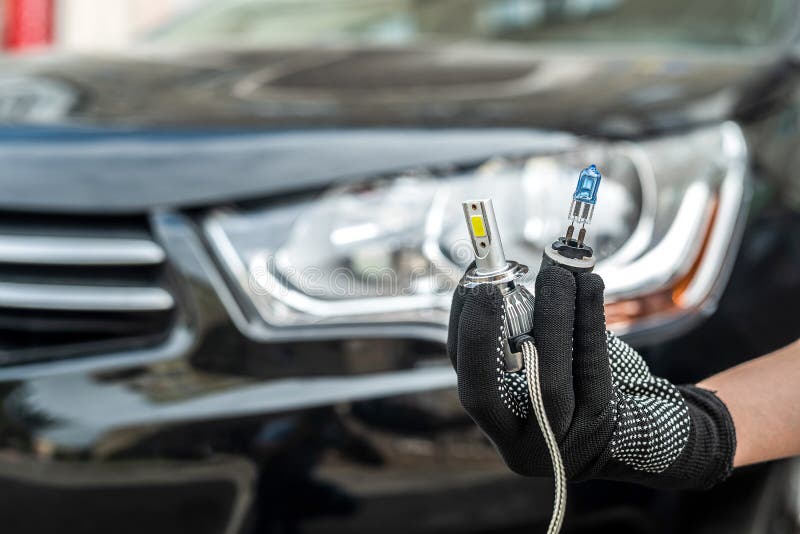The Mechanic Chooses between Light Bulbs Stock Photo - Image of light ...