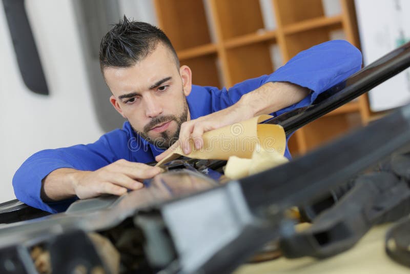 Mechanic cleaning car part stock image. Image of machine - 280480253