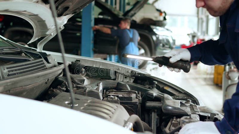 The Mechanic Conducts a Visual Inspection of the Car Engine Stock ...