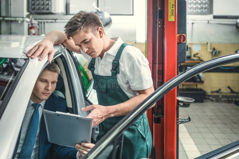 Mechanic and customer stock photo. Image of occupation - 88760090