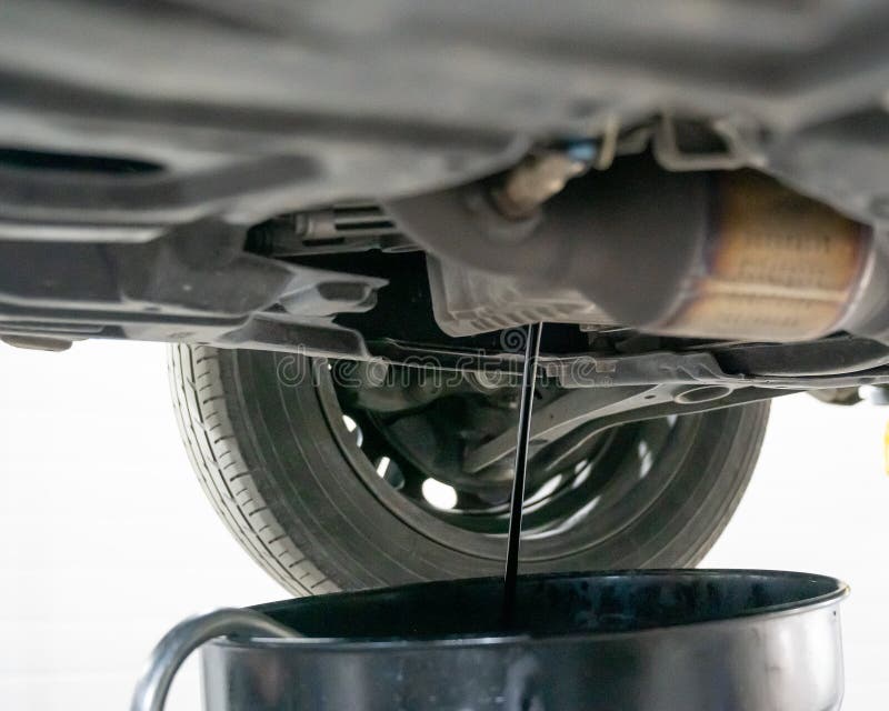 A Mechanic Drains a Car S Used Engine Oil. Stock Image - Image of used ...