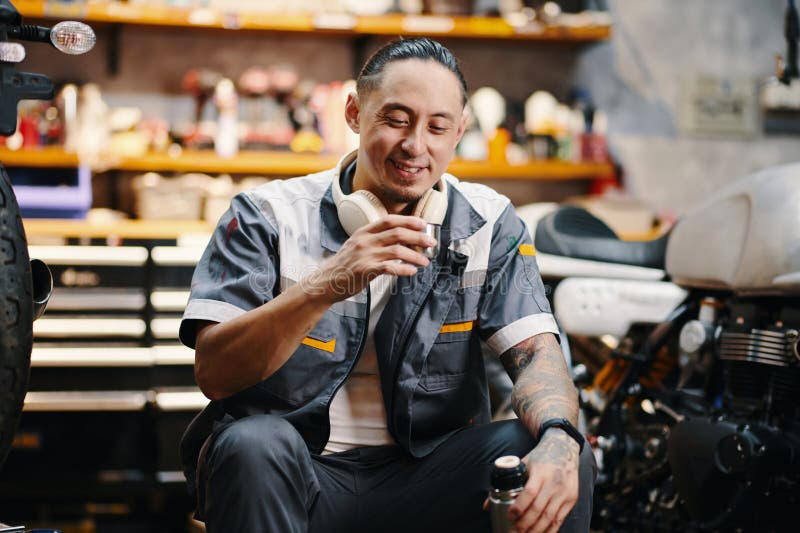 Mechanic Drinking Coffee during Break Stock Image - Image of positive ...