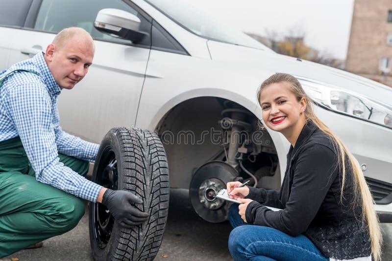 Mechanic and Driver Looking at Spare Wheel Stock Image - Image of ...