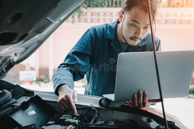 Mechanic Engineer is Diagnosing Car Engine and Electric Adjusting ...