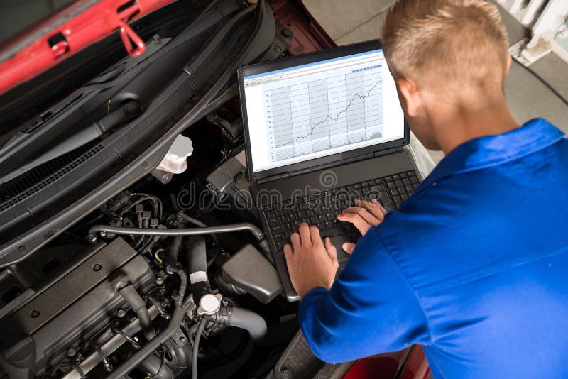 Mechanic Examining Car Engine with Help of Laptop Stock Photo - Image ...