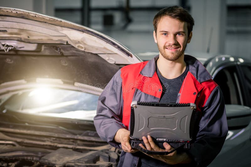 Mechanic Examining Car Engine with Help of Laptop Stock Image - Image ...