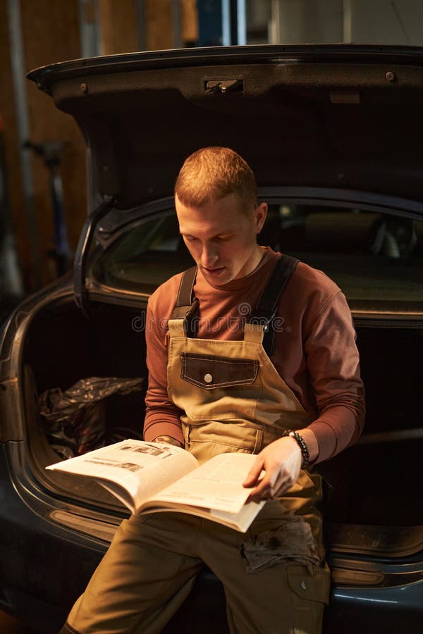 Mechanic Examining Instruction of Car Engine Stock Image - Image of ...