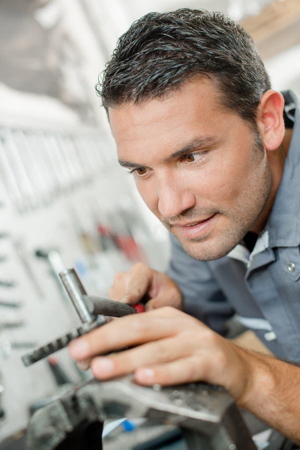 Mechanic filing metal part stock photo. Image of scrape - 118387872