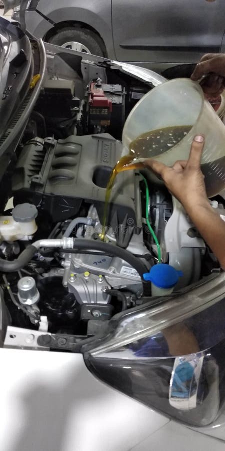 Mechanic Putting Engine Oil in a Car. Editorial Photography - Image of ...