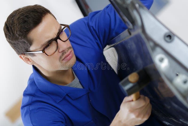 Mechanic fitting car door stock photo. Image of production - 249172340