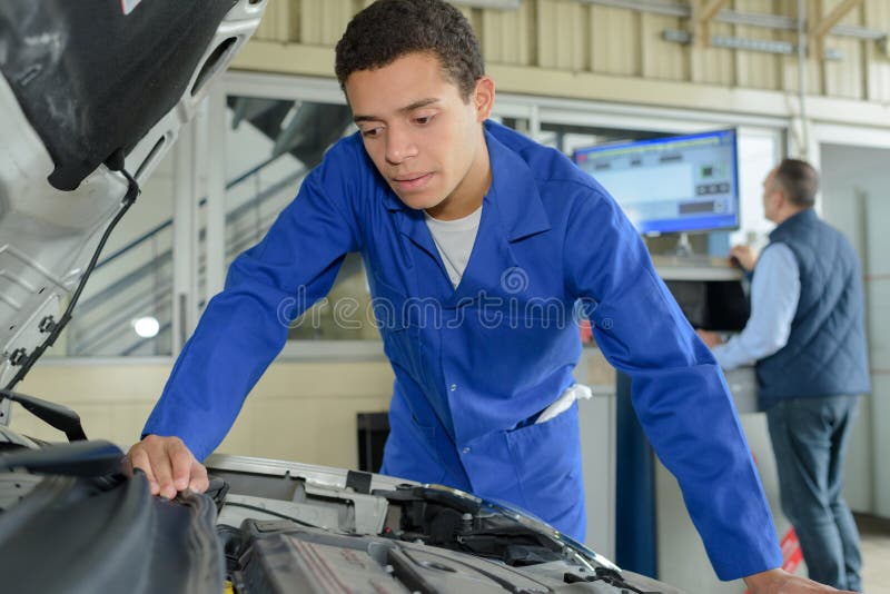 Mechanic Fixing Car Engine in Garage Stock Photo - Image of open, shop ...