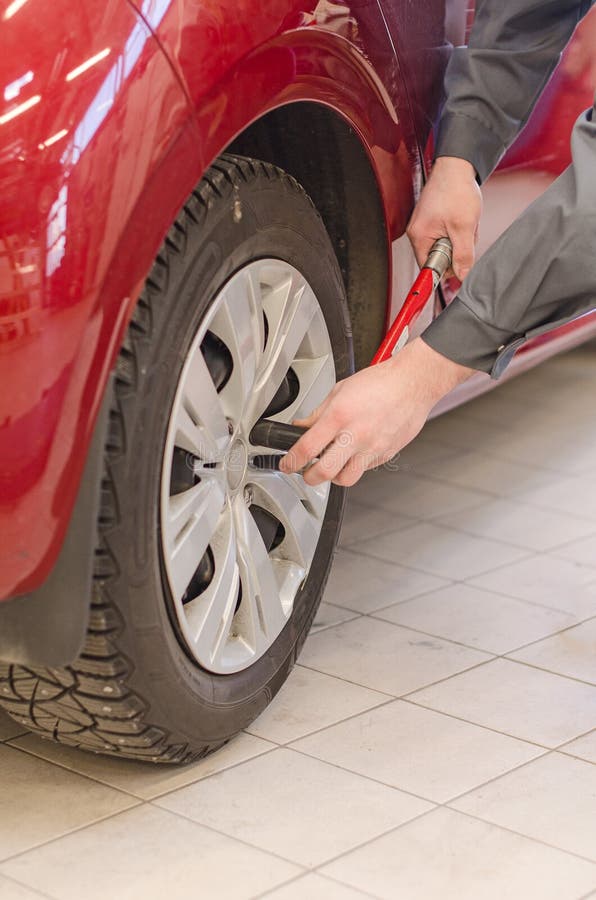 Mechanic fixing car wheel. stock photo. Image of transport - 40202984