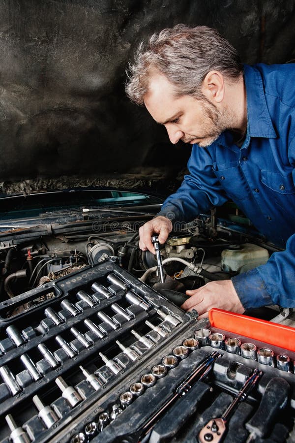 Mechanic fixing an engine stock photo. Image of worker - 35587988