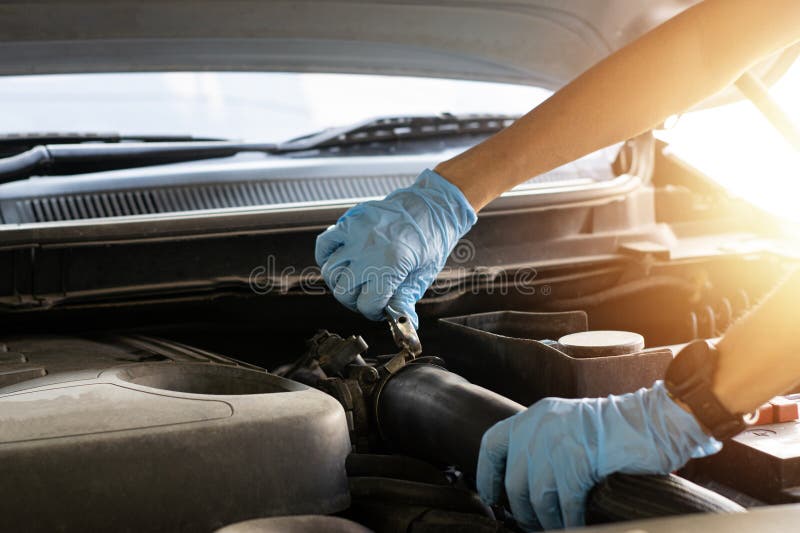 The Mechanic is Fixing the Engine, Using a Wrench To Tighten the Nuts ...