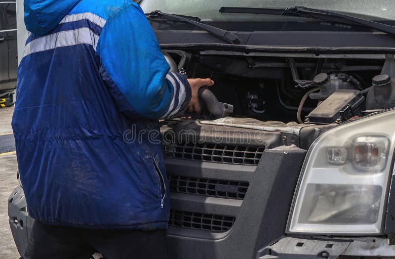 Mechanic Fixing the Engine of a Van Stock Image - Image of engineer ...
