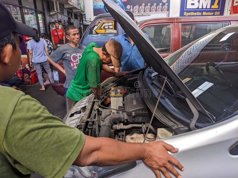 A Mechanic is Fixing the Front Engine of the Car Editorial Image ...