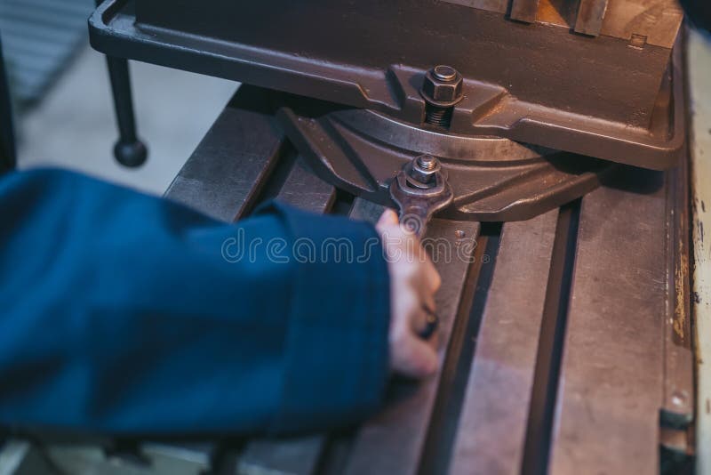 The Mechanic Fixing Machine in Warehouse. a Man Puts an Aluminum Piece ...