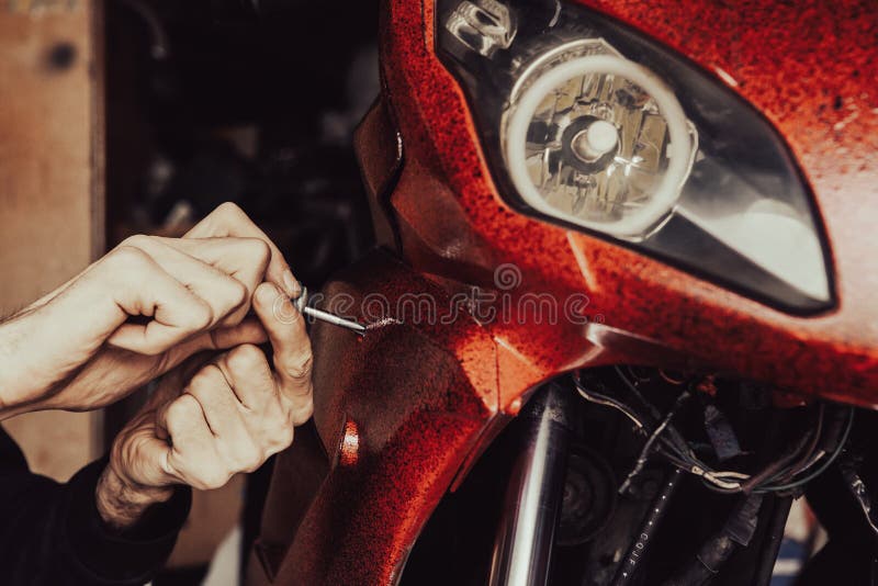 Mechanic Fixing a Motorcycle in the Garage Stock Photo - Image of ...