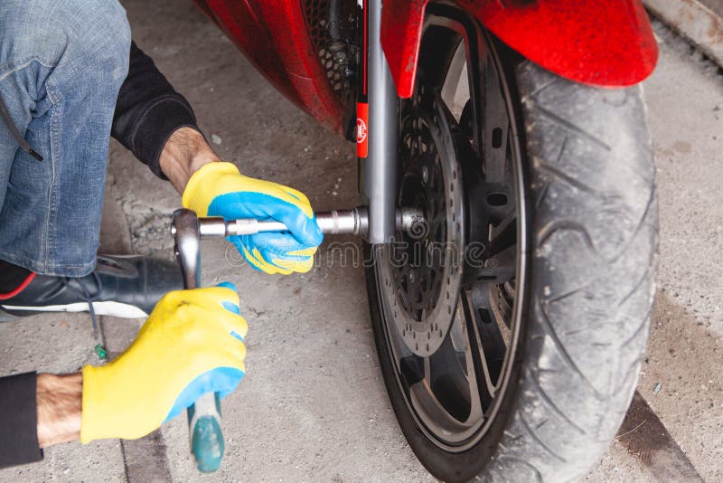 Mechanic Fixing a Motorcycle in the Garage Stock Image - Image of ...