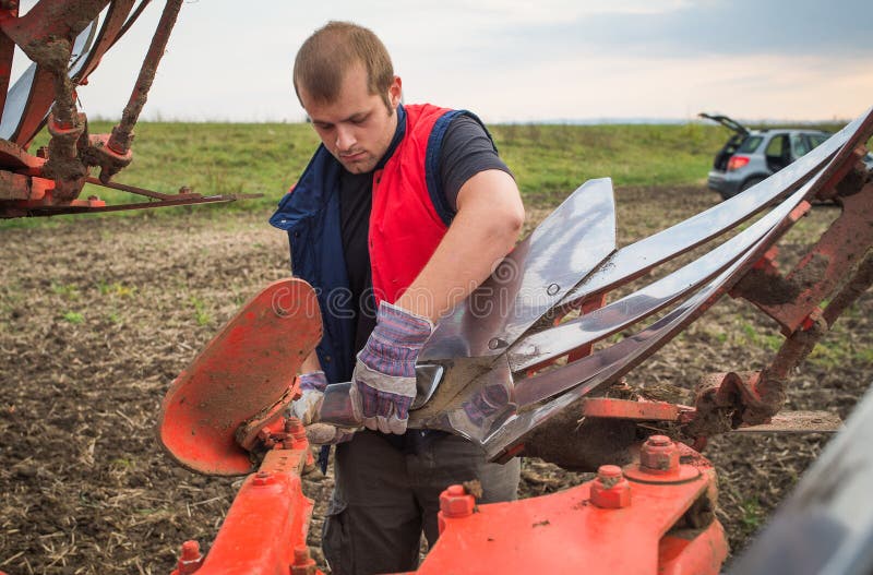 Mechanic Fixing Plow on the Tractor Stock Photo - Image of agriculture ...